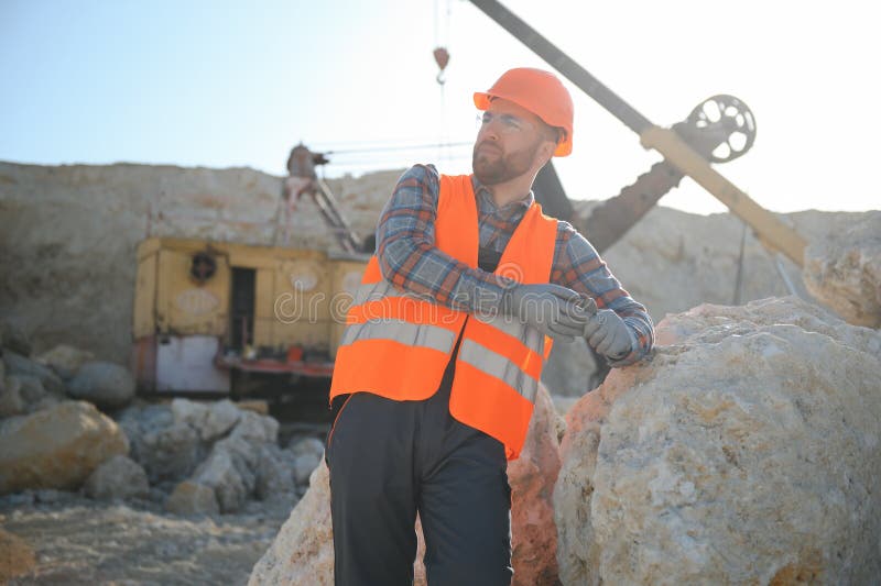 Extraction of Stone. Male Worker Next To Stone Quarry Stock Photo ...