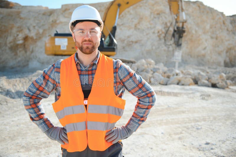 Extraction of Stone. Male Worker Next To Stone Quarry Stock Photo ...
