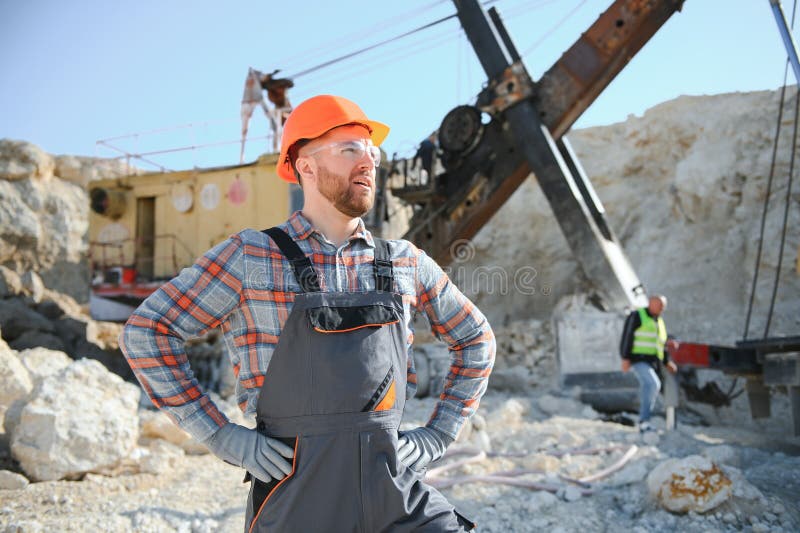 Extraction of Stone. Male Worker Next To Stone Quarry Stock Photo ...