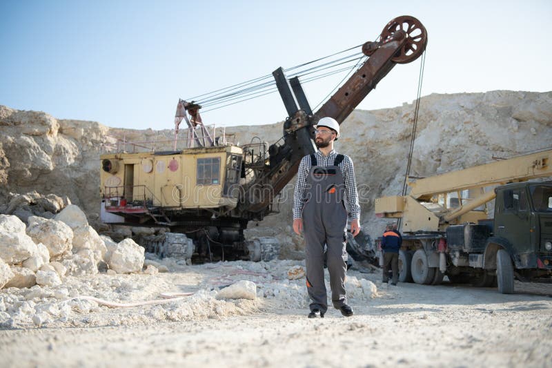 Extraction of Stone. Male Worker Next To Stone Quarry Stock Image ...