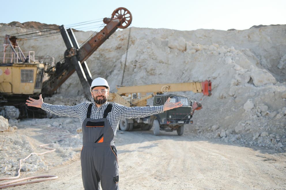 Extraction of Stone. Male Worker Next To Stone Quarry Stock Photo ...