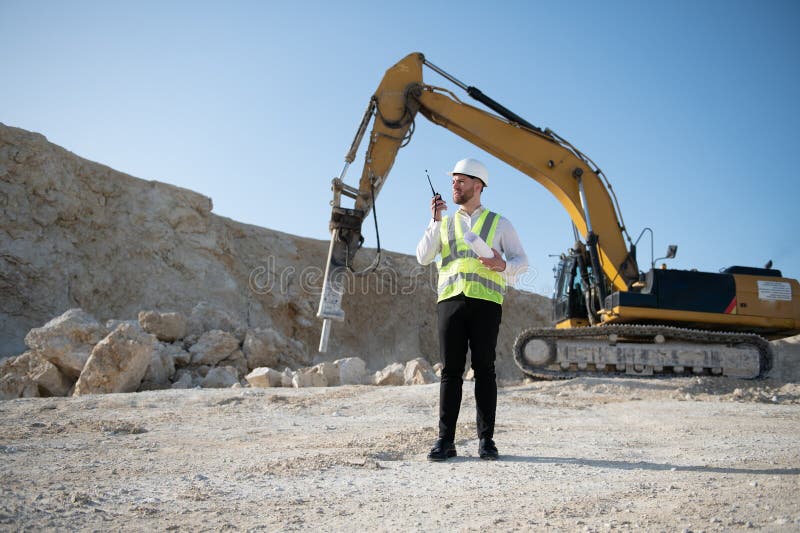 Extraction of Stone. Male Worker Next To Stone Quarry Stock Photo ...