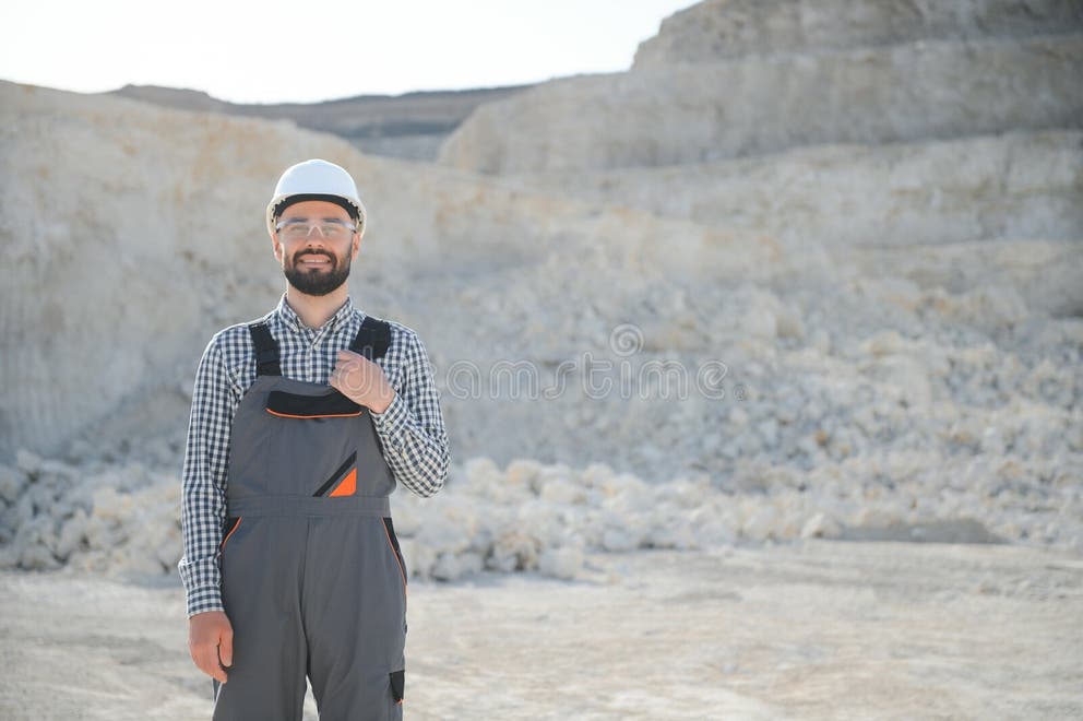 Extraction of Stone. Male Worker Next To Stone Quarry Stock Photo ...
