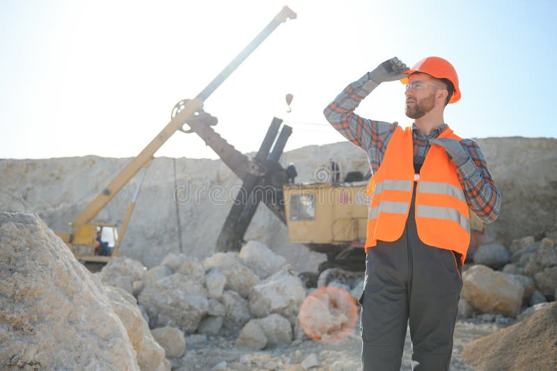 Extraction of Stone. Male Worker Next To Stone Quarry Stock Photo ...