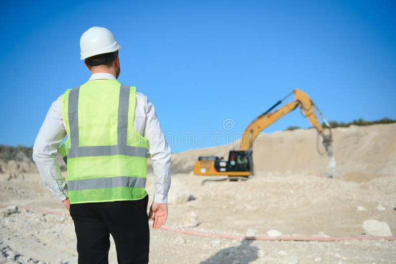 Extraction of Stone. Male Worker Next To Stone Quarry Stock Photo ...