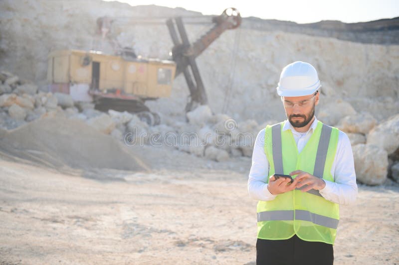 Extraction of Stone. Male Worker Next To Stone Quarry Stock Photo ...