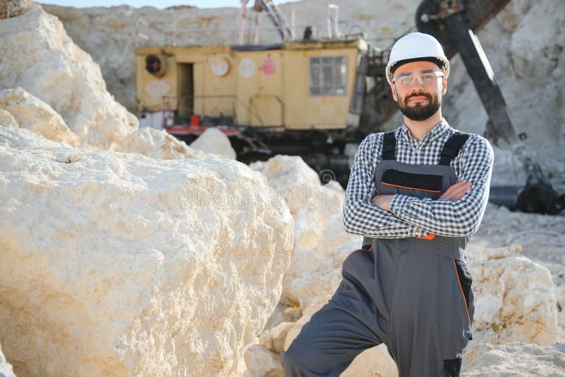Extraction of Stone. Male Worker Next To Stone Quarry Stock Photo ...