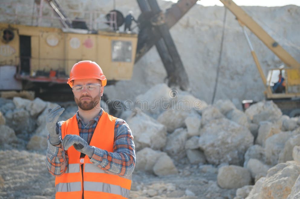 Extraction of Stone. Male Worker Next To Stone Quarry Stock Photo ...