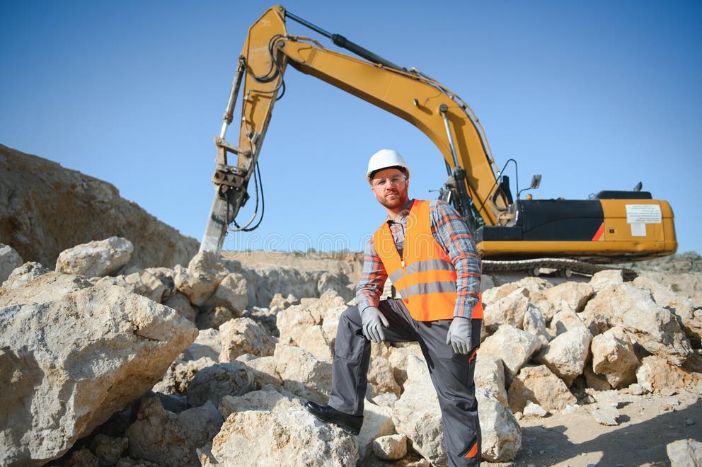 Extraction of Stone. Male Worker Next To Stone Quarry Stock Photo ...
