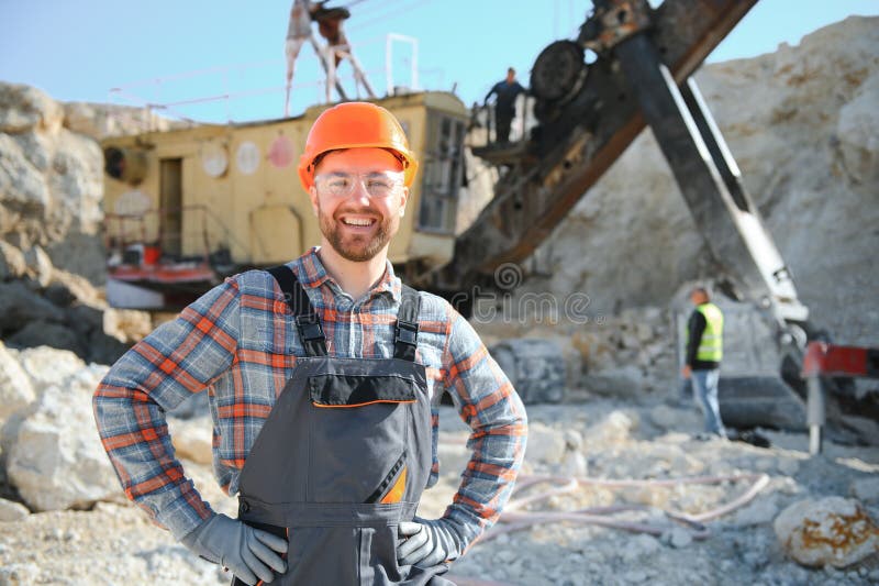 Extraction of Stone. Male Worker Next To Stone Quarry Stock Photo ...