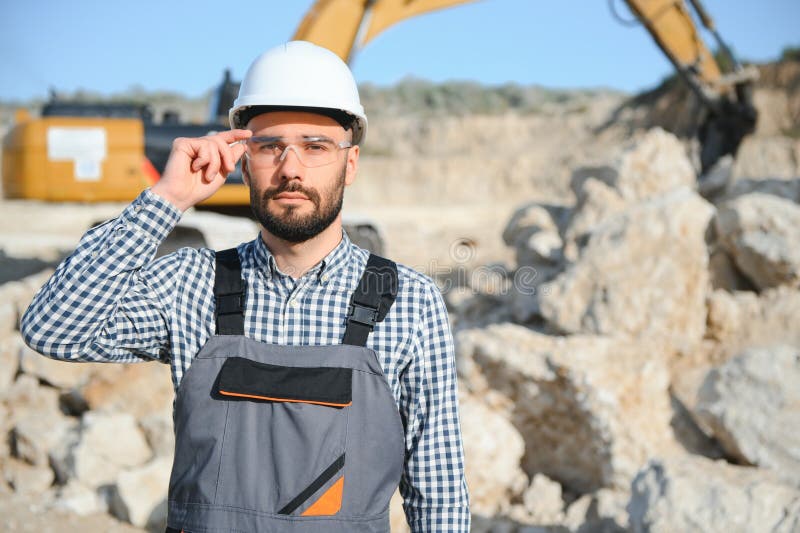 Extraction of Stone. Male Worker Next To Stone Quarry Stock Photo ...
