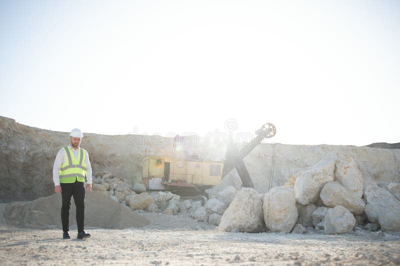 Extraction of Stone. Male Worker Next To Stone Quarry Stock Photo ...