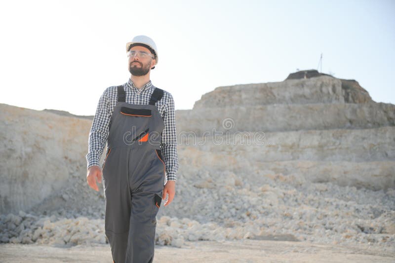 Extraction of Stone. Male Worker Next To Stone Quarry Stock Photo ...