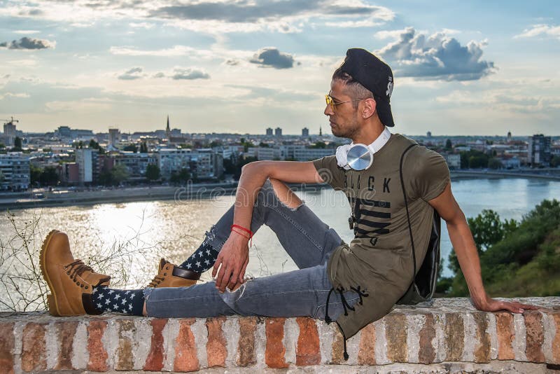 Extravagant Hipster Male Model is Singing on a Wooden Bench. Stock ...