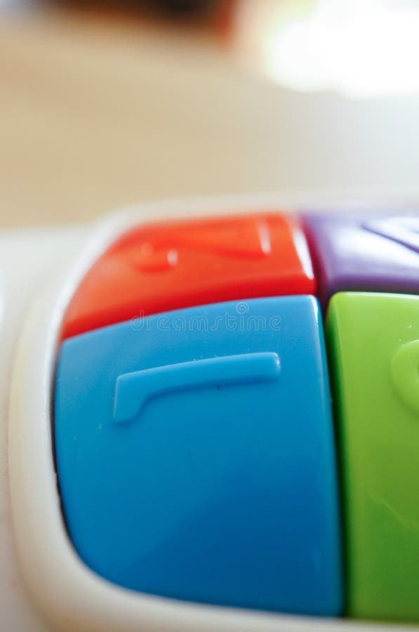 Extreme Closeup of a Blue Button of a Toy with the Number One on it ...