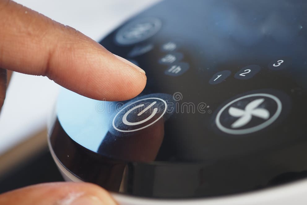 An Extreme Closeup View of a Finger Pressing the Power Button on a ...