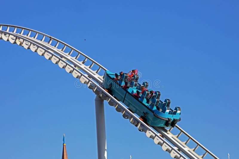 Extreme Rollercoaster at Speed Against the Blue Sky. Attractions ...