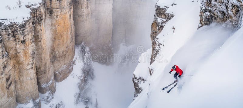 Extreme Skier Skiing Down Steep Snowy Mountain Slope between Cliffs ...