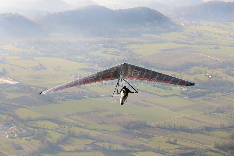 Man Flying with Hang Glider Above the Plain. this is Extreme Spo Stock ...