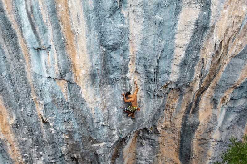Extreme Sport, Strong Man, Rock Climber Climbs a Difficult Route Stock ...