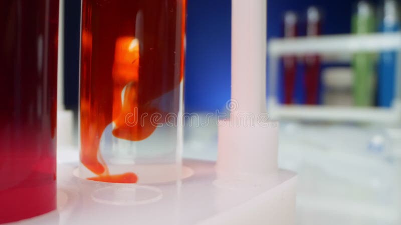 Chemical Experiments. Red Liquid Dissolves in a Clear Liquid in a Test ...