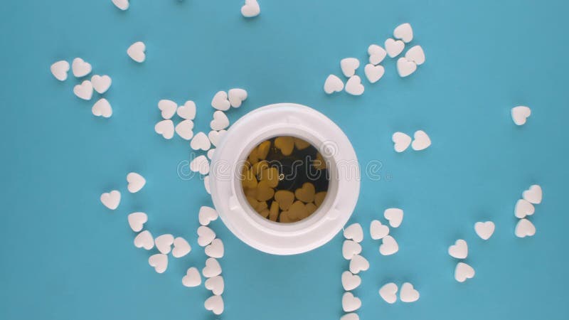 Extremely Close-up, Detailed. White Heart-shaped Pills in a Bottle ...