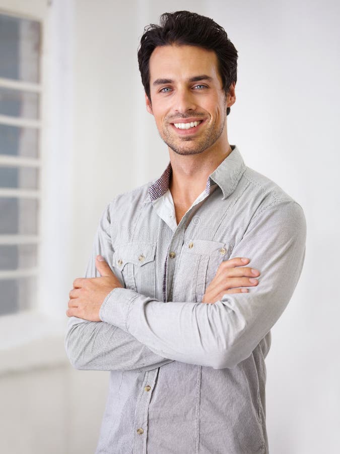 He Exudes Confidence Portrait Of A Smiling Handsome Man With His Arms