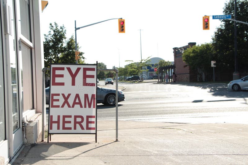 Eye Exam Here Writing Text Caption Sandwich Board Sign in Front of ...