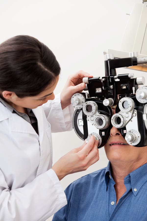 Optometrist Adjusting Patient's Head For Retinal Stock Photo - Image of ...