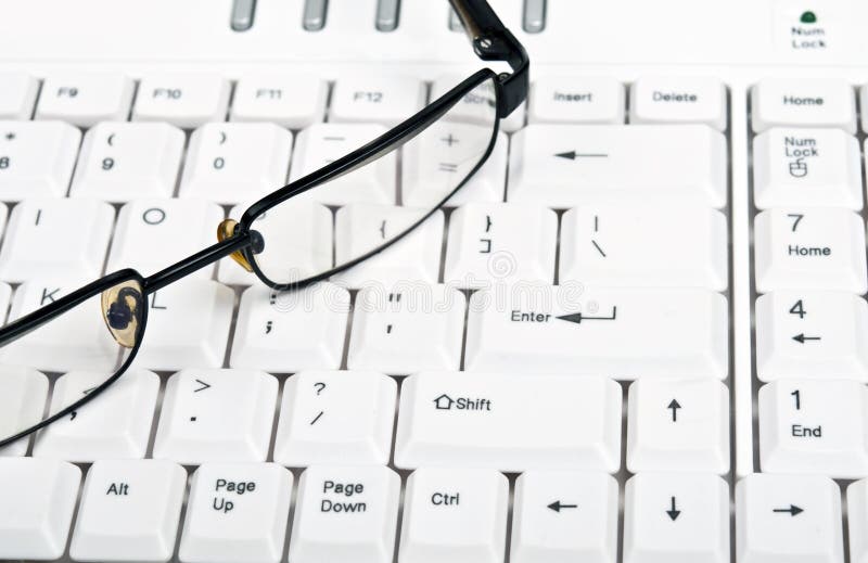 Eye glasses on keyboard stock image. Image of business - 20696457