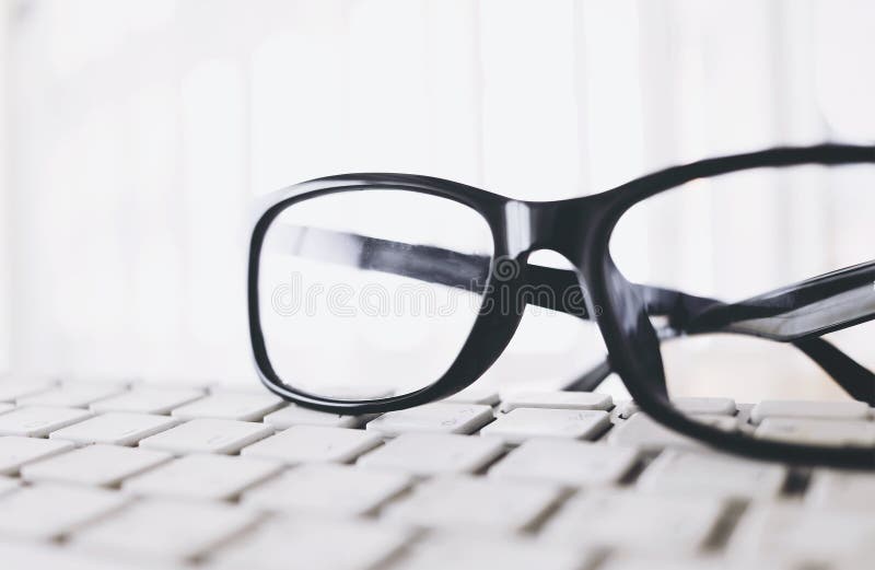 Eye glasses on keyboard stock image. Image of business - 97220489