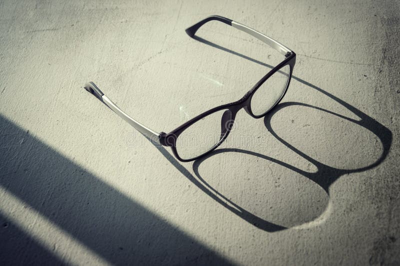 Eye Glasses with Light and Shadow on Rough Floor Stock Image - Image of ...