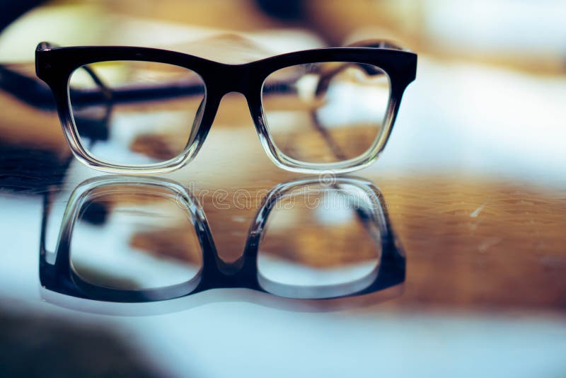 Eye Glasses on Wood Table with Reflection Stock Photo - Image of ...