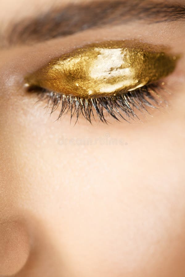 Eye with golden make-up stock image. Image of body, shot - 68917075
