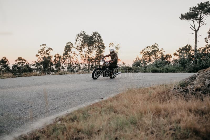 Eye-level Shot of a Biker Driving a Motorcycle during the Sunset Stock ...