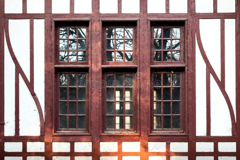 Eye-level Shot of the Facade of a Building with a Window with a Wooden ...