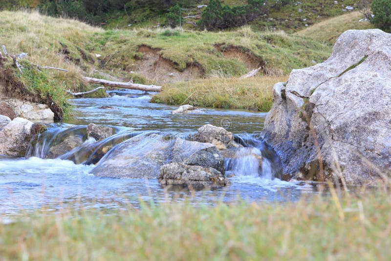 Eye-level Shot of a Small Waterfall of a River in a Field Stock Image ...