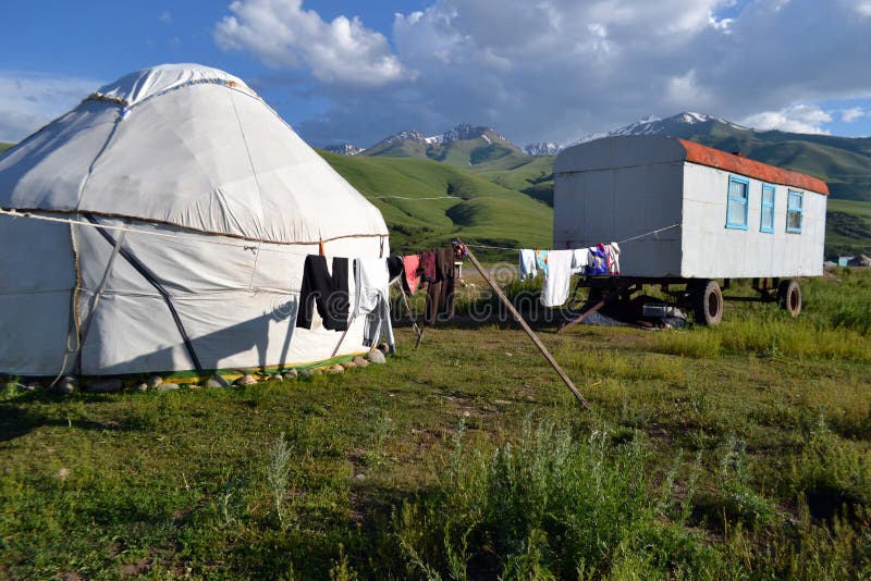 Eye-level Shot of a Yurt and a Metal Trailer with Laundry Drying on a ...