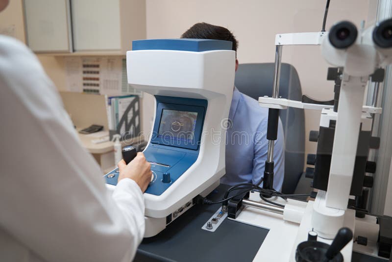 Eye Physician Checking Man Sight with Autorefractor Stock Photo - Image ...