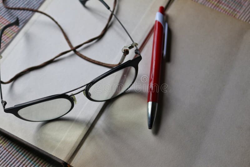 Eyeglass with book and pen stock photo. Image of eyeglass - 84451638