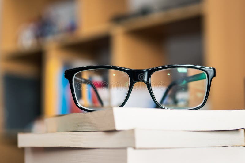 Eyeglasses and Books in Library Stock Image - Image of lens, spectacles ...