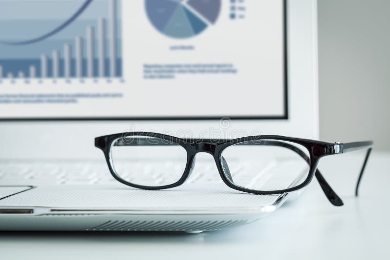 Eyeglasses on computer stock image. Image of chart, computer - 76599593