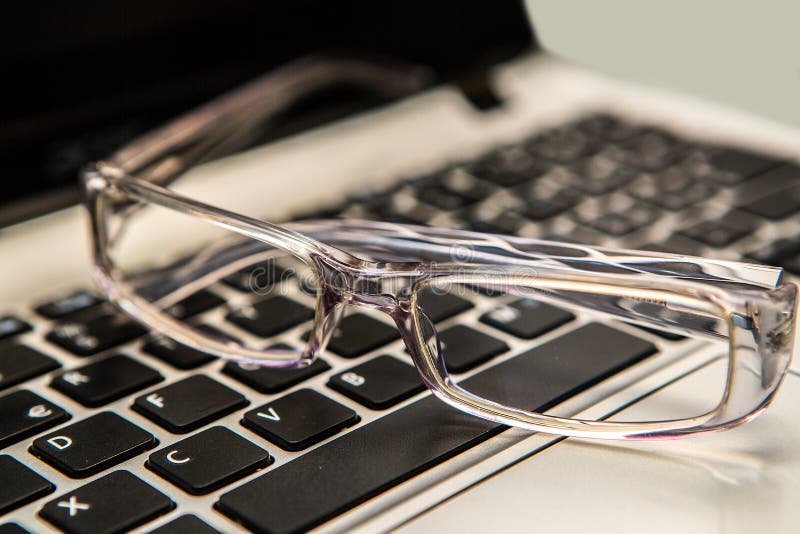 Eyeglasses with keyboard stock image. Image of astigmatism - 51966079