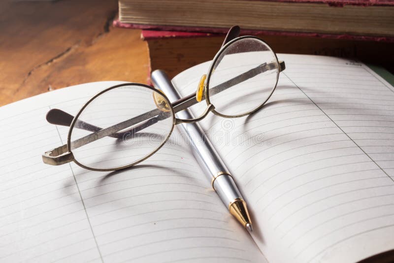 Eyeglasses and Pen on Book. Stock Photo - Image of lens, note: 37111704