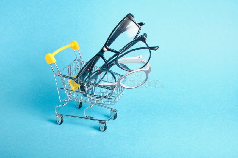 Eyeglasses in Shopping Cart, Blue Background Stock Photo - Image of ...