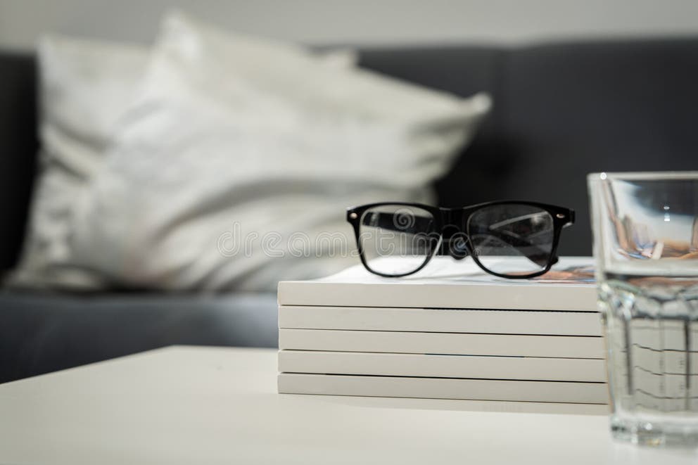 Eyeglasses with Stack of Books, and the Glass of Water on the Table ...