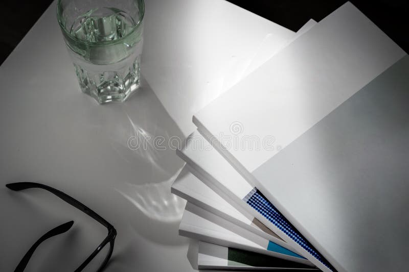 Eyeglasses with Stack of Books, and the Glass of Water on the Table ...