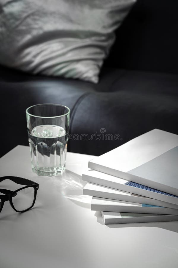 Eyeglasses with Stack of Books, and the Glass of Water on the Table ...