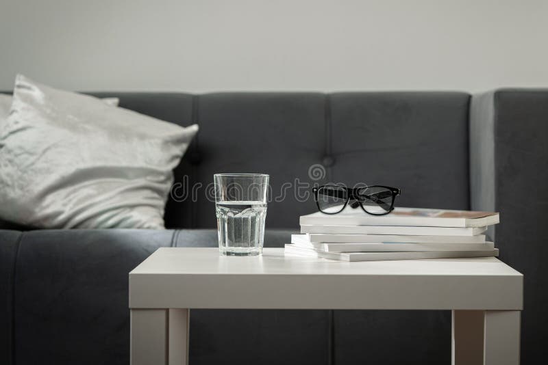 Eyeglasses with Stack of Books, and the Glass of Water on the Table ...