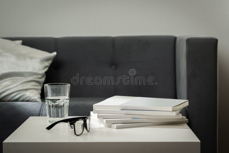 Eyeglasses with Stack of Books, and the Glass of Water on the Table ...